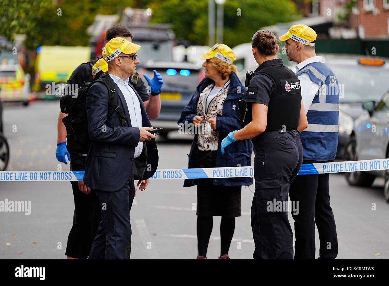 Members of the Community Security Trust (CST) speak to a police officer ...