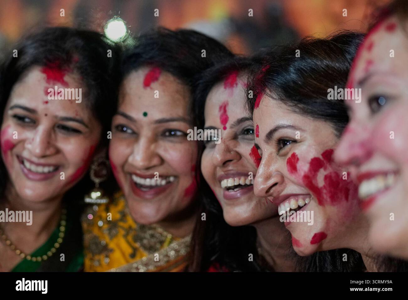 Hindu women smear vermillion on each other and pose for photographs on ...