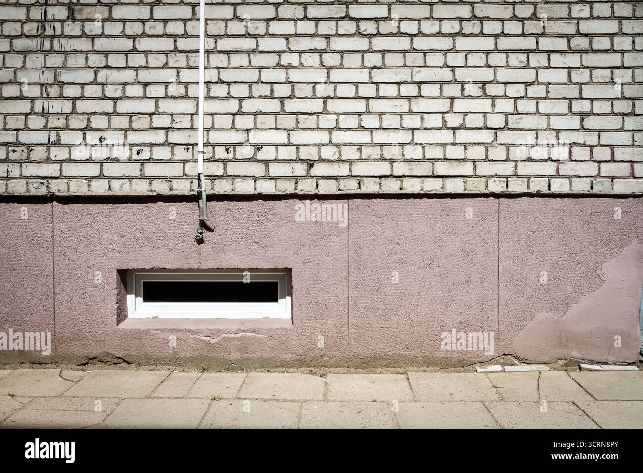White brick wall with some cables and basement window. Architectural ...