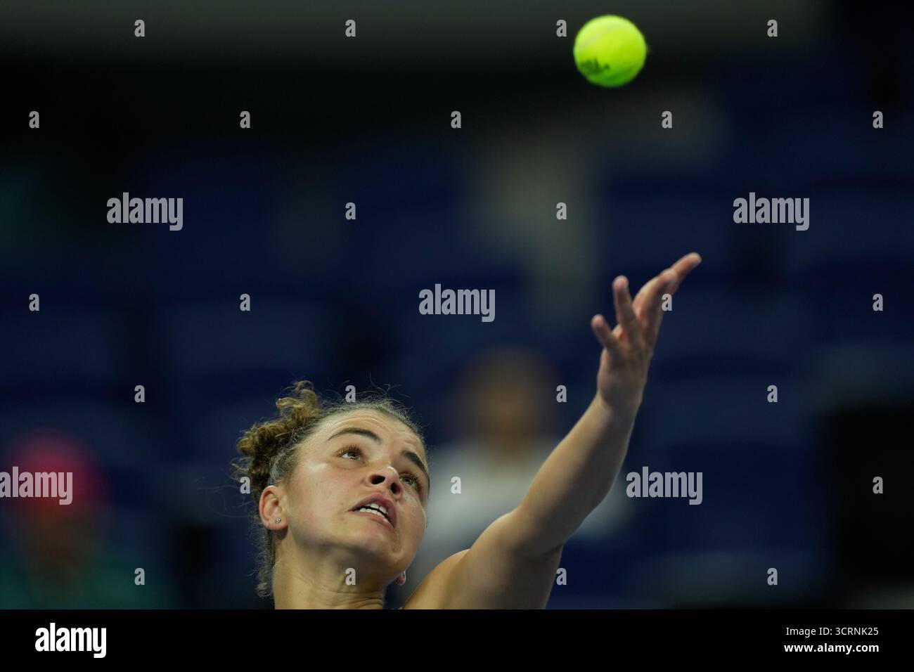 Jasmine Paolini, of Italy tosses the ball to serve against Amanda ...