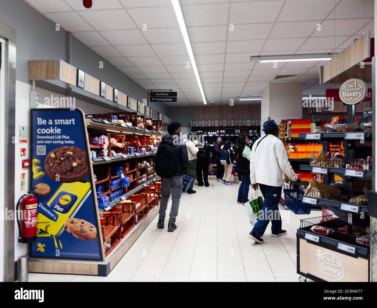 Manchester, UK - September 25, 2025: Shoppers browse snacks and bakery ...