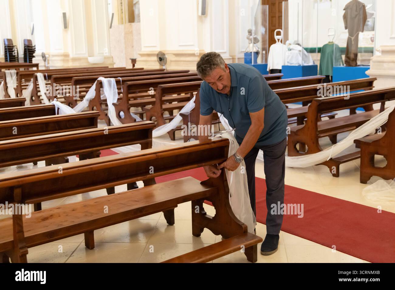 Preparing catholic church interior for wedding ceremony. Noto, Italy ...