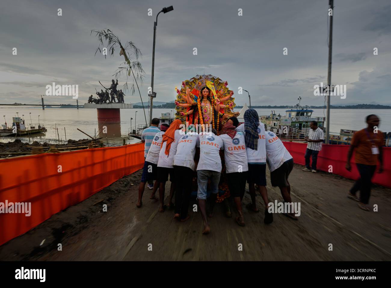Municipal employees carry an idol of Hindu goddess Durga to emmers in ...