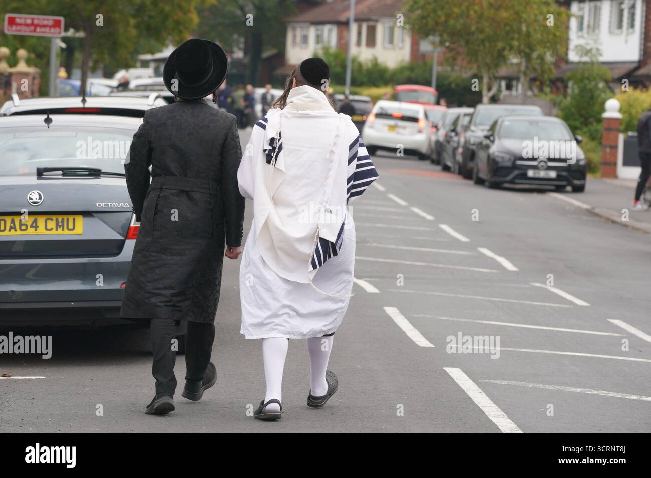 Orthodox Jewish men walk near the scene of a stabbing incident at ...