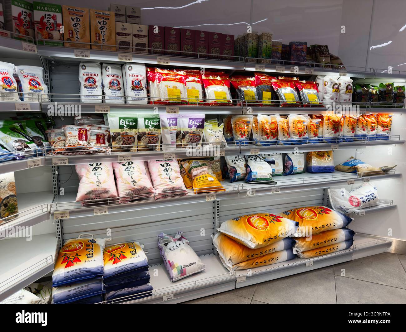 Manchester, UK - September 25, 2025: Colorful rice bags line the ...