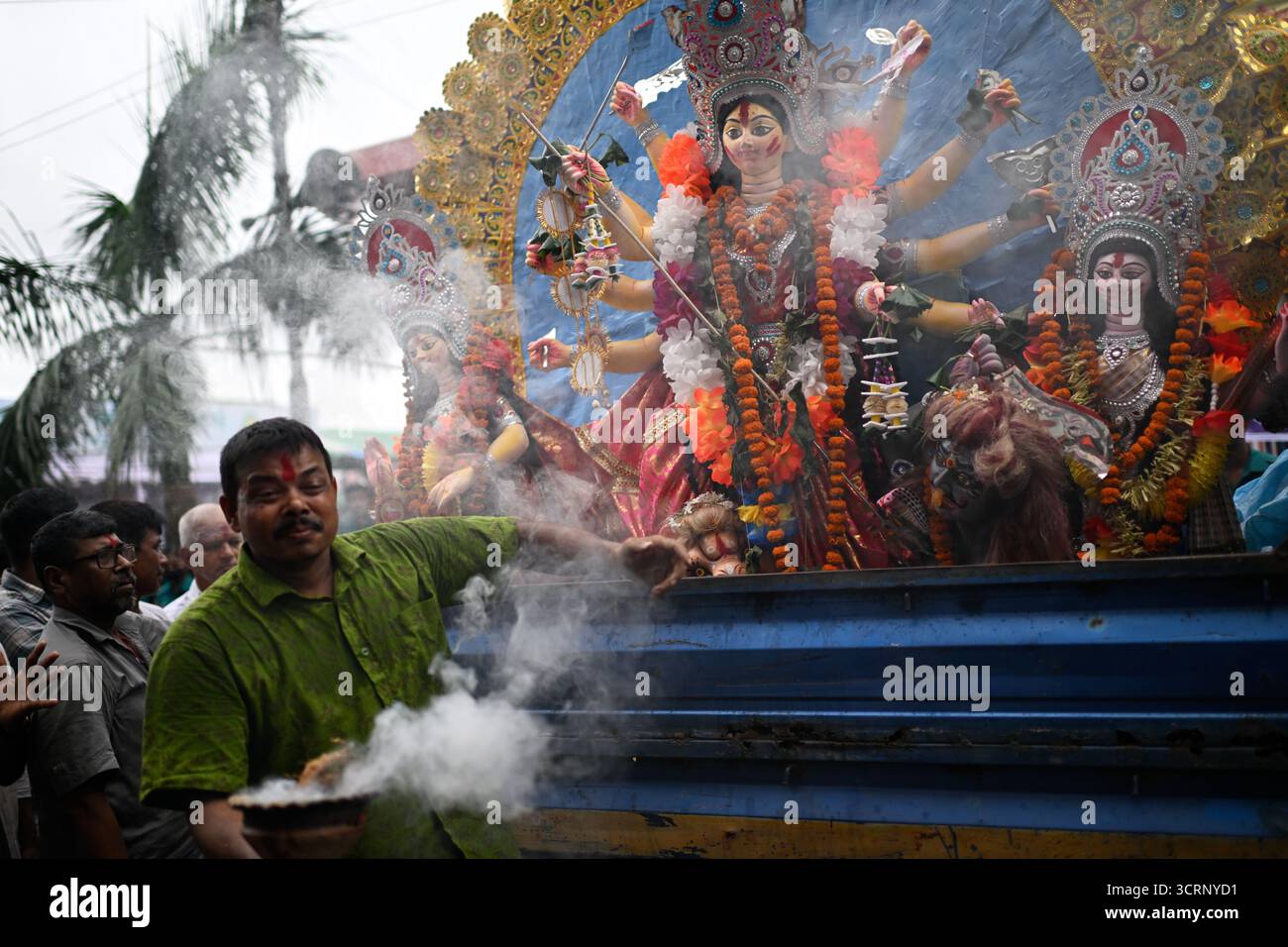Devotees carry an idol of the Hindu goddess Durga for immersion in the ...