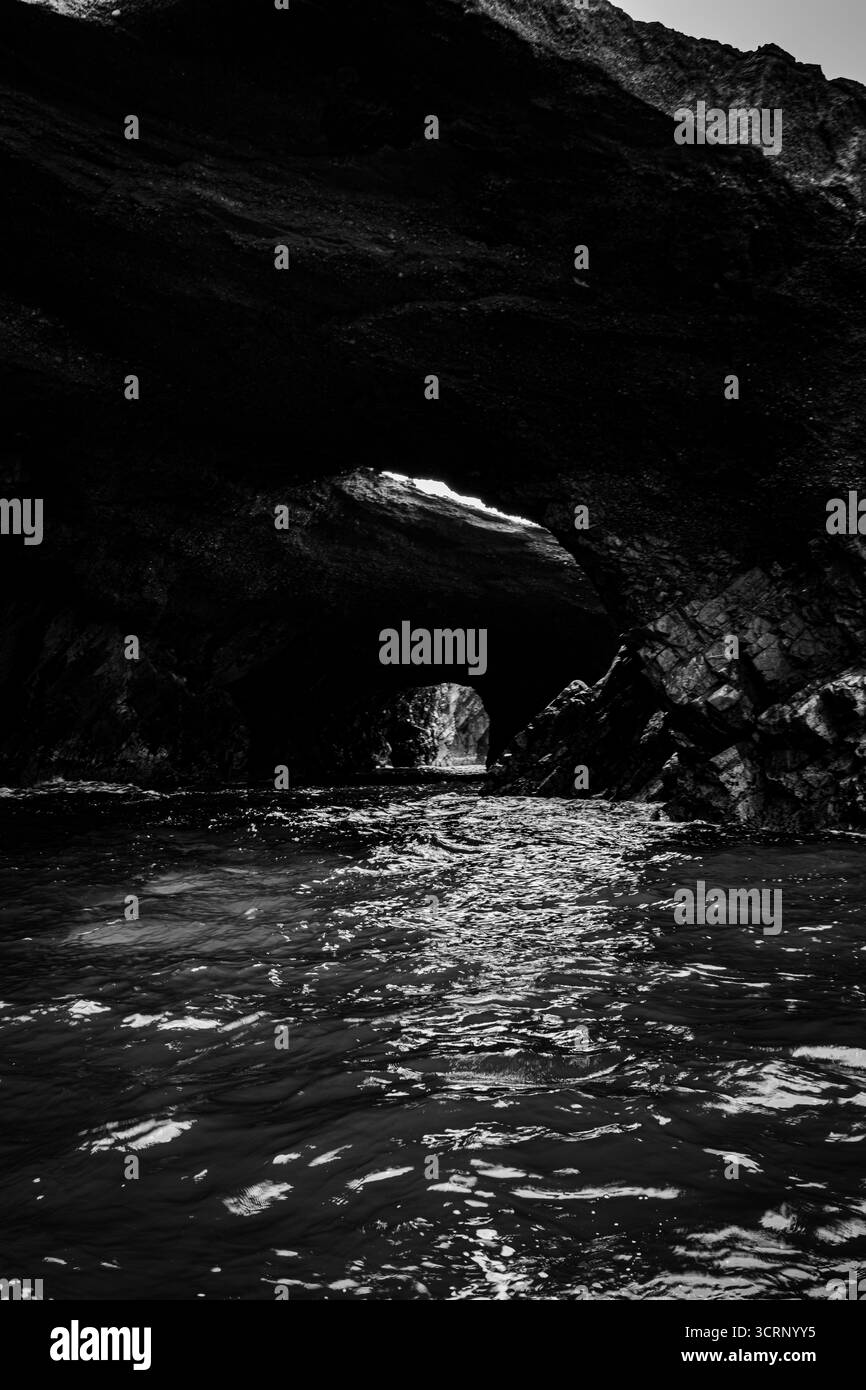 Dark sea cave opening viewed from the water at the Ballestas Islands ...