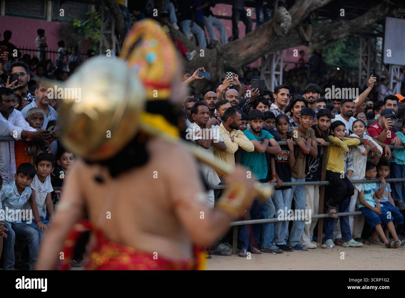 People watch a procession during Dussehra festival in Jammu, India ...