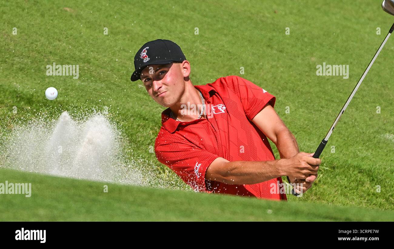 Louisville golfer Easton Johnson hits out of the bunker on the 13th ...