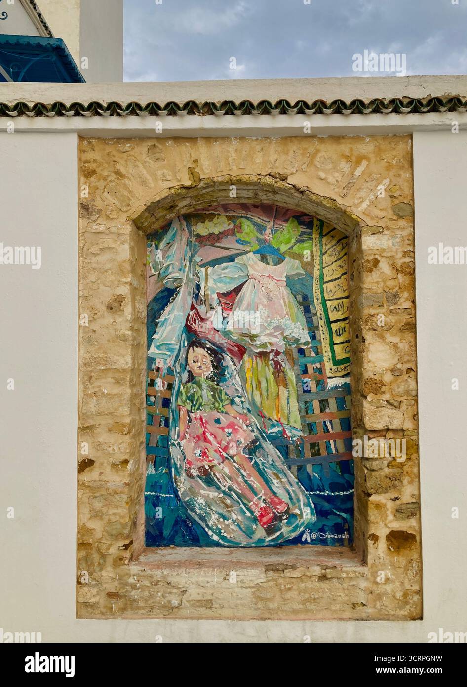 Colorful mural embedded in stone wall at Ibn Bou Said tomb complex ...