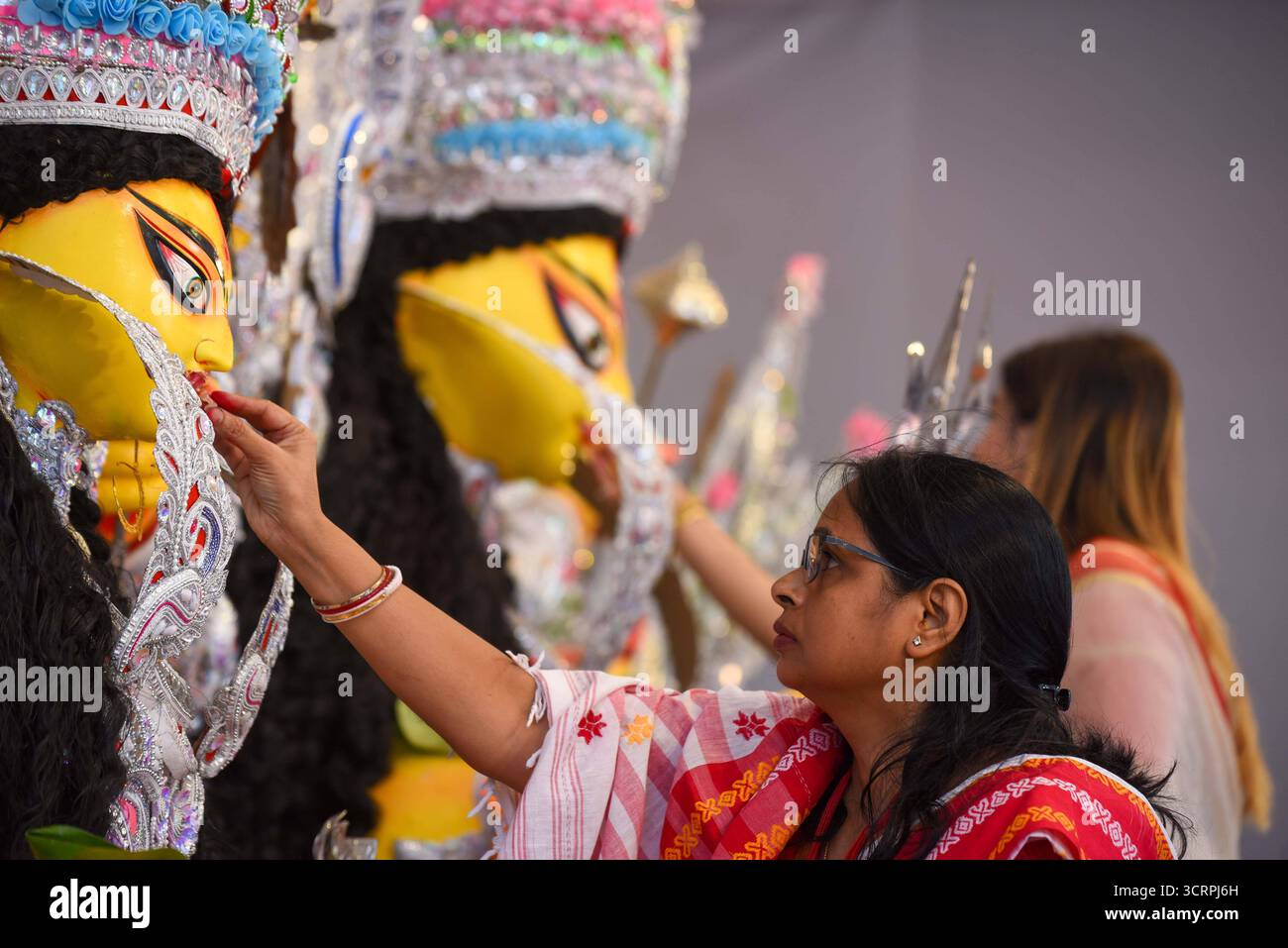 GURUGRAM, INDIA - OCTOBER 2: A woman performs rituals on an idol of ...