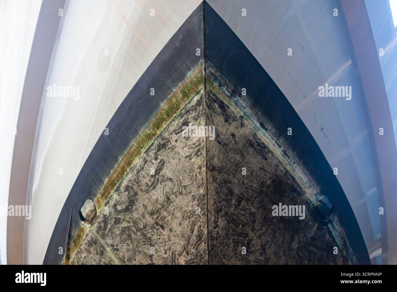 The bow of the yacht, bottom view, close-up. The waterline is clearly ...