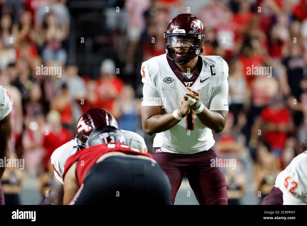 Virginia Tech quarterback Kyron Drones (1) surveys the defense of North ...