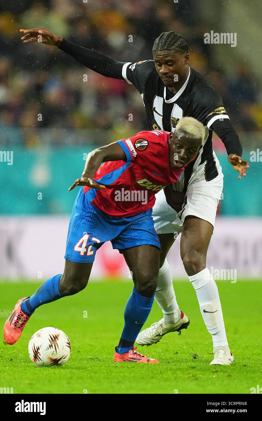 FCSB's Baba Alhassan, left, challenges for the ball with Young Boys ...