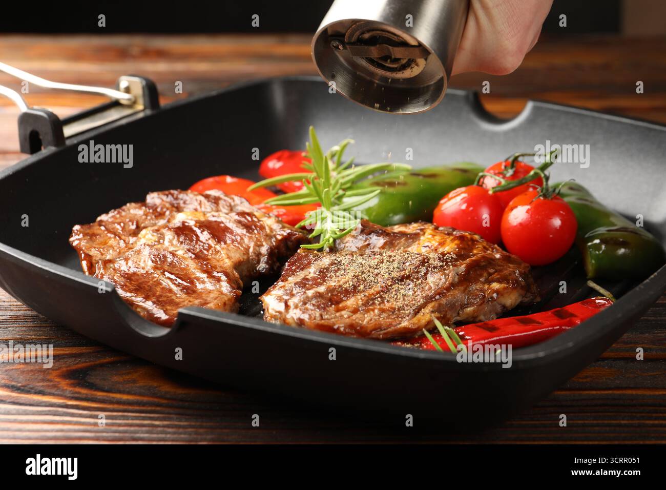 Woman adding pepper grilled hi-res stock photography and images - Alamy