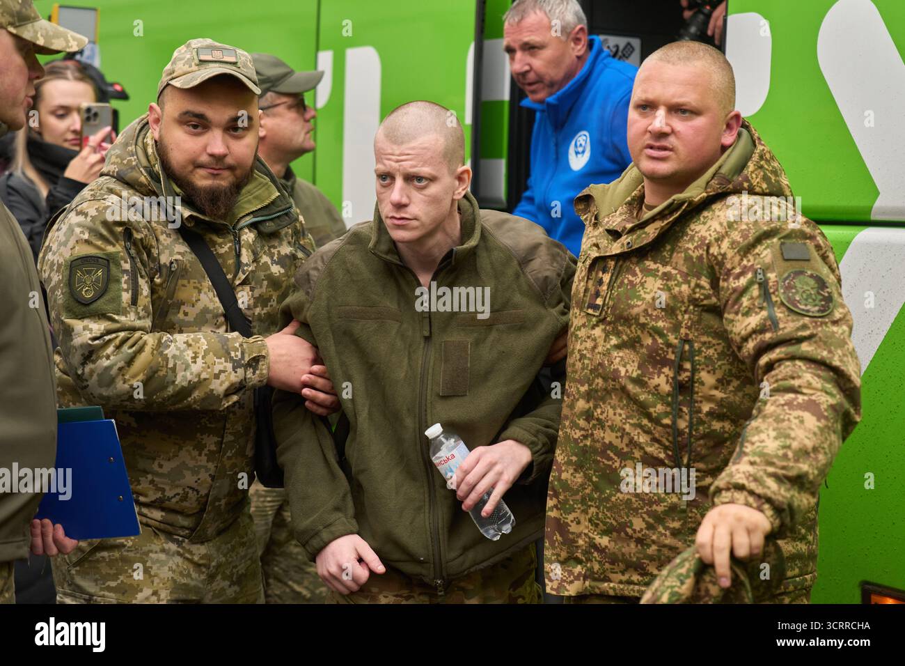Servicemen help a soldier returning from Russian captivity during a POW ...