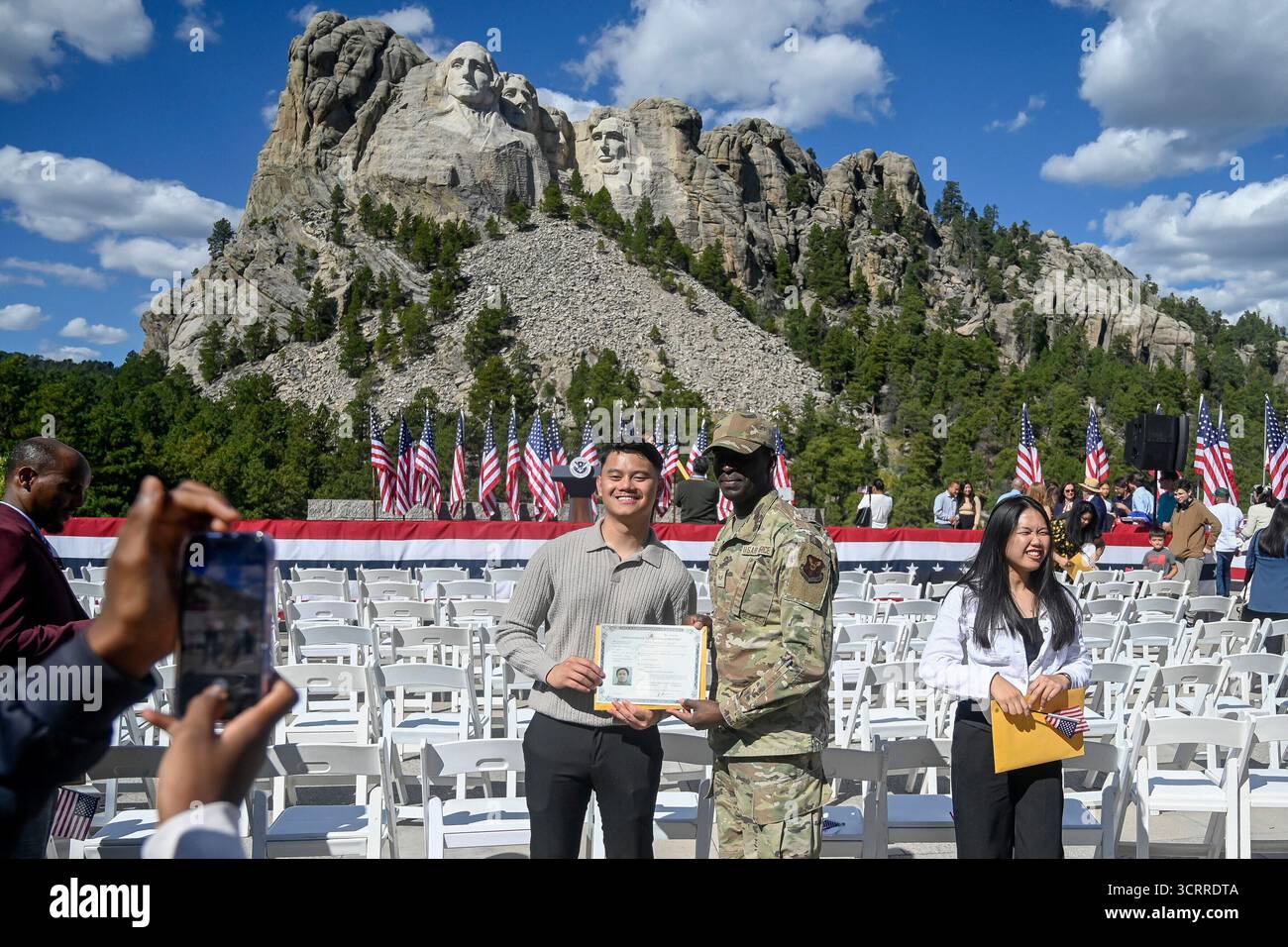Several of the 72 new U.S. citizens take pictures following a ...