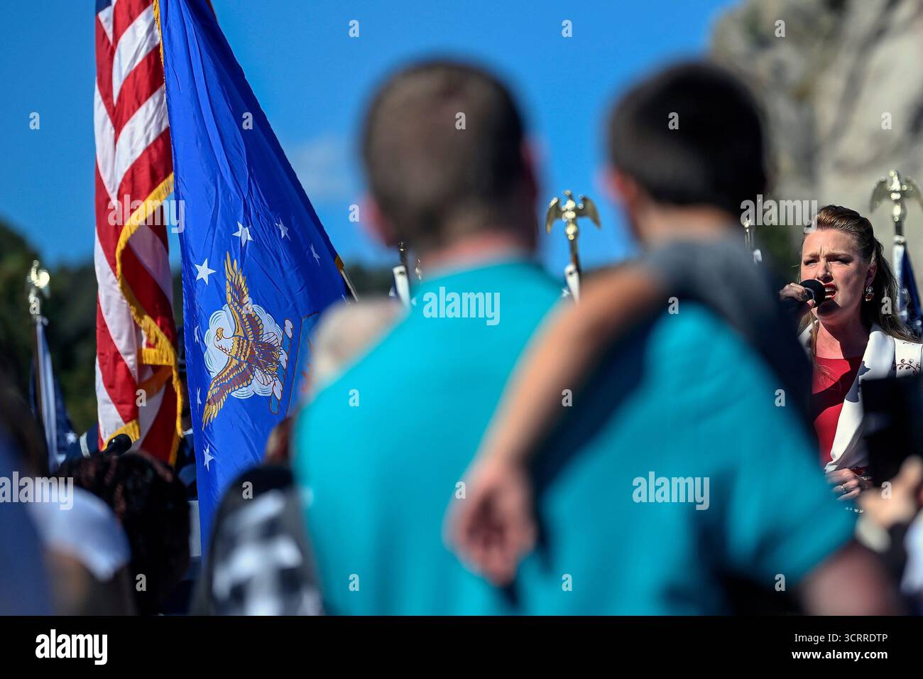 Sara Frankenstein, right, sings The Star-Spangled Banner during a ...