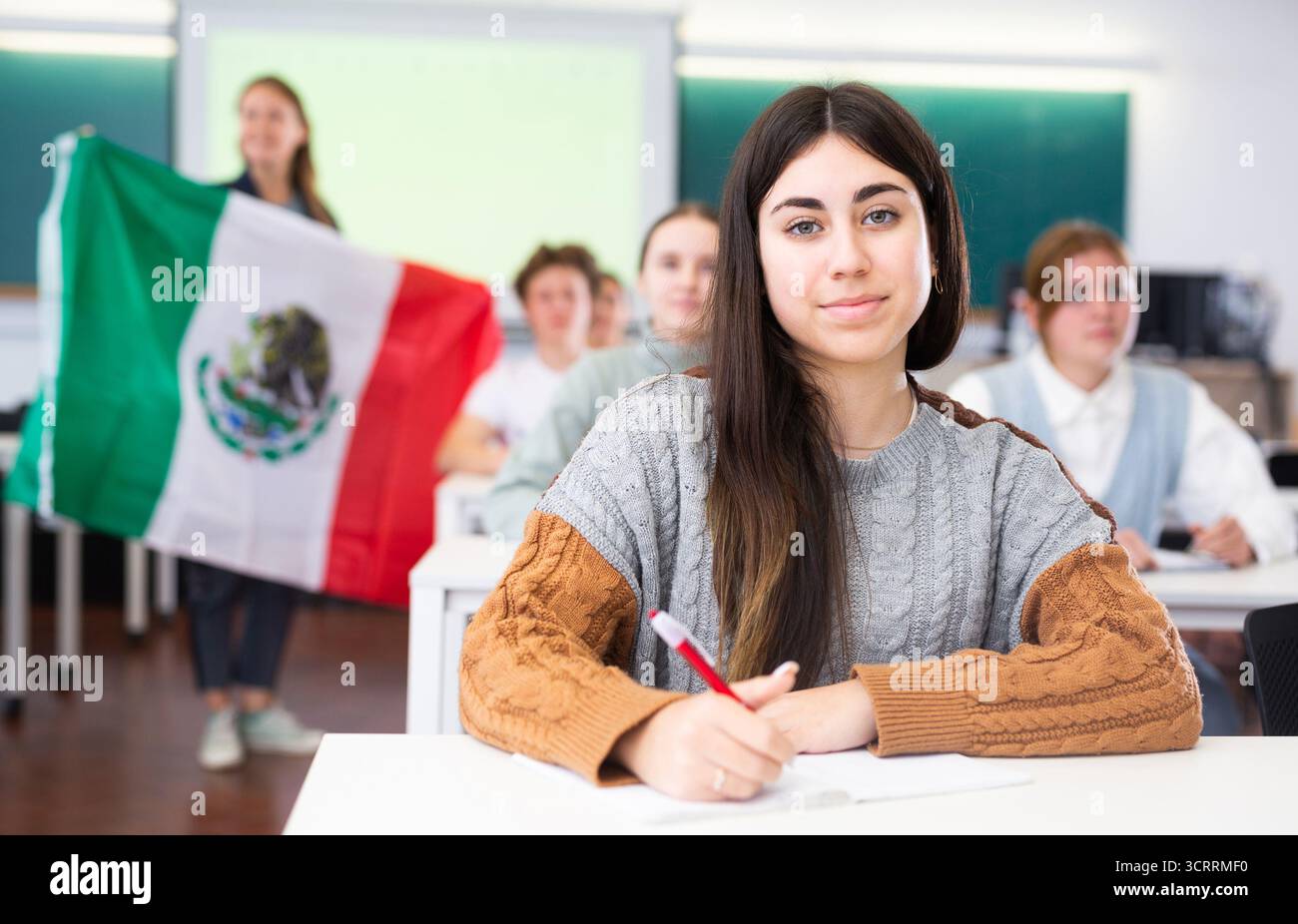 Teacher stands behind students with Mexican flag Stock Photo - Alamy