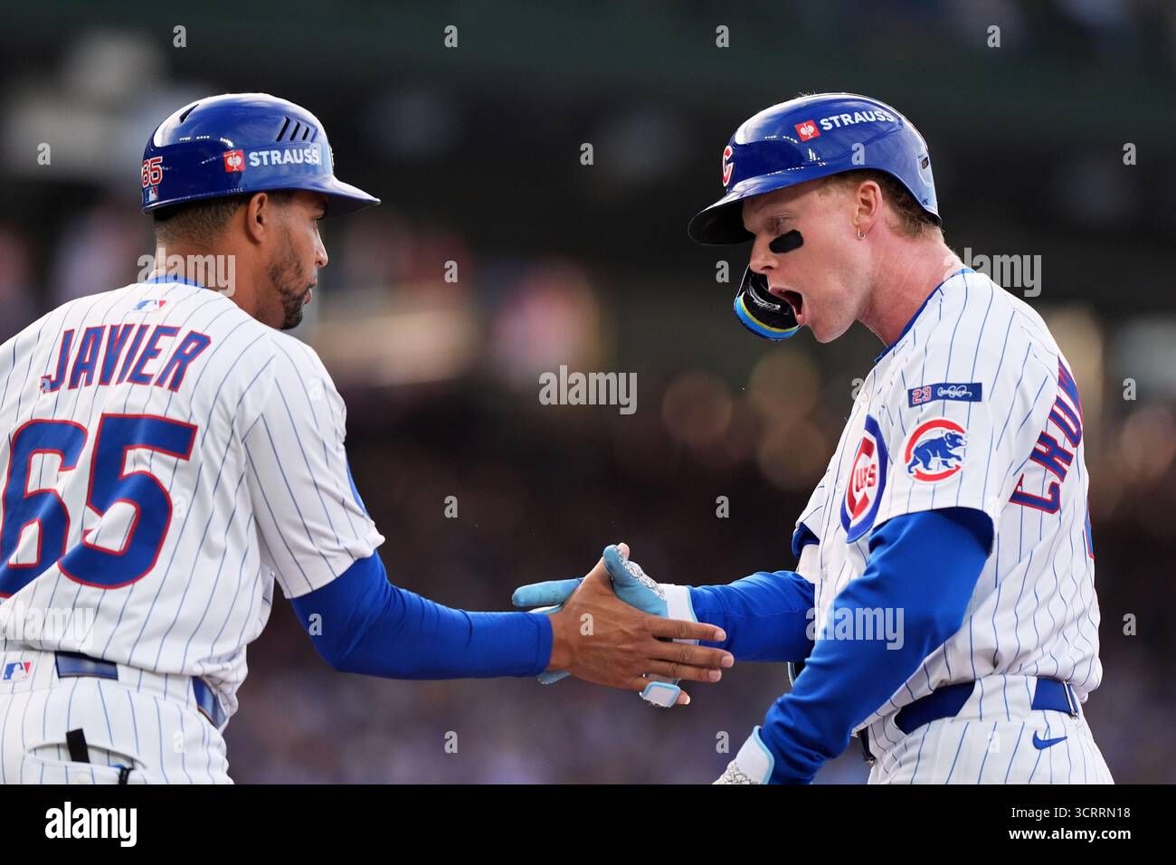 Chicago Cubs first base coach Jose Javier congratulates Pete Crow ...