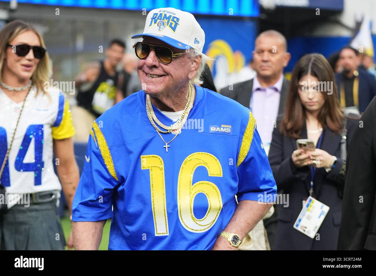 Professional wrestler Ric Flair walks on the field before an NFL ...
