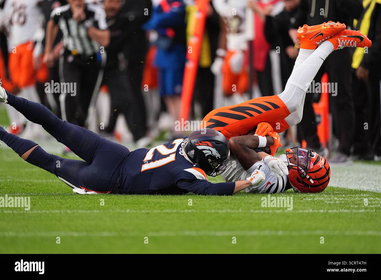 Denver Broncos cornerback Riley Moss (21) tackles Cincinnati Bengals ...