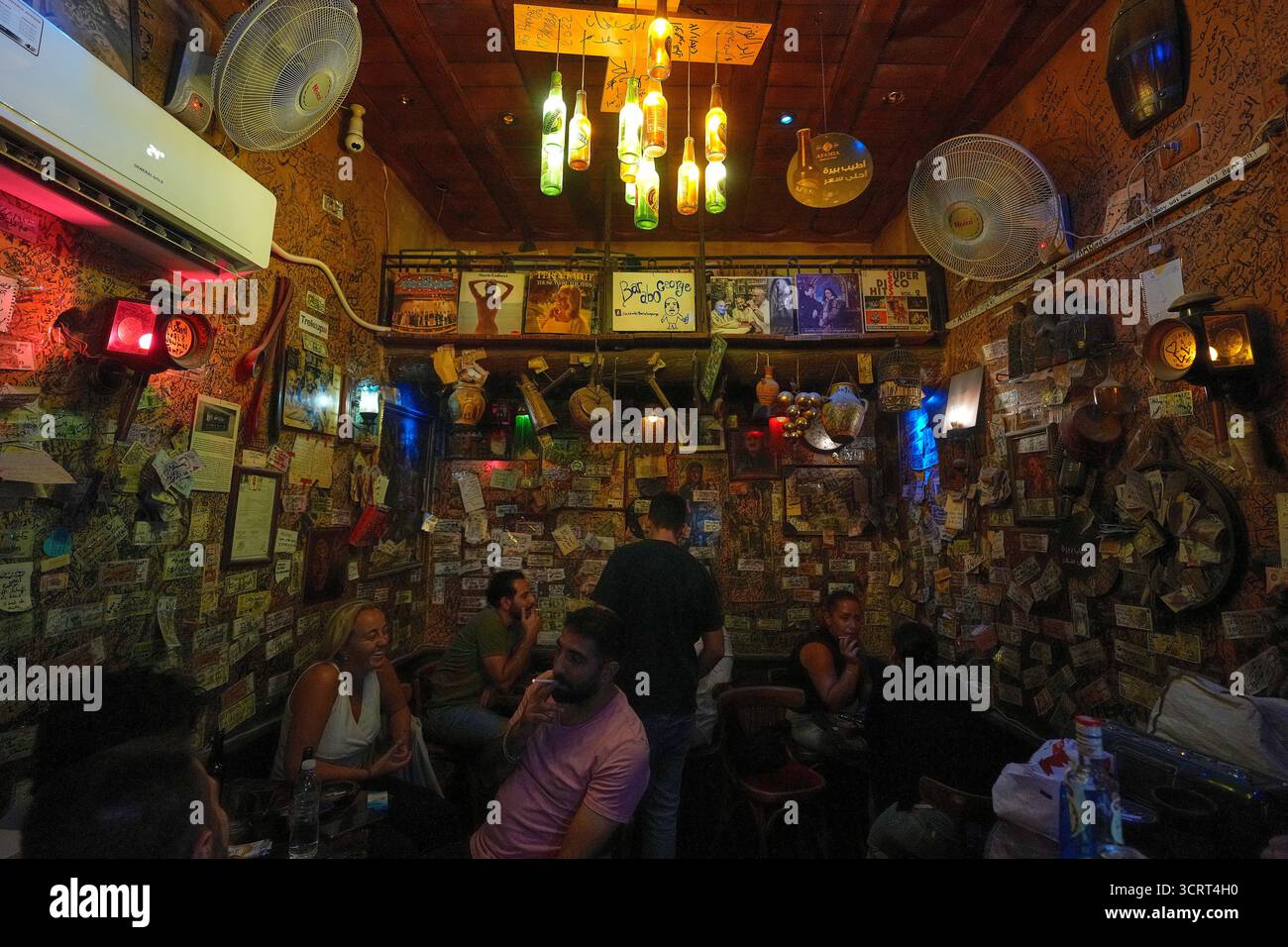 People sit at a bar as they enjoy the first night of the weekend in ...