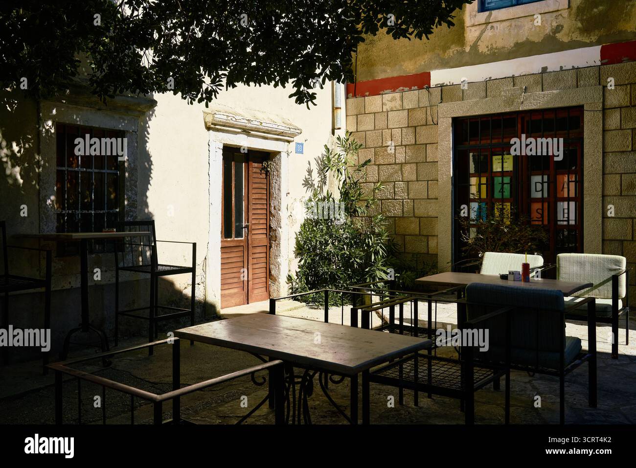 Shaded Mediterranean Cafe Terrace with Historic Stone Walls and ...