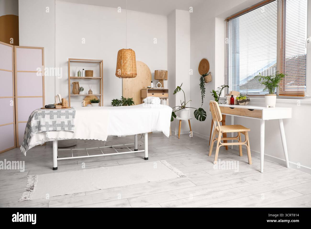 Interior of massage therapist's office with couch, workplace and ...