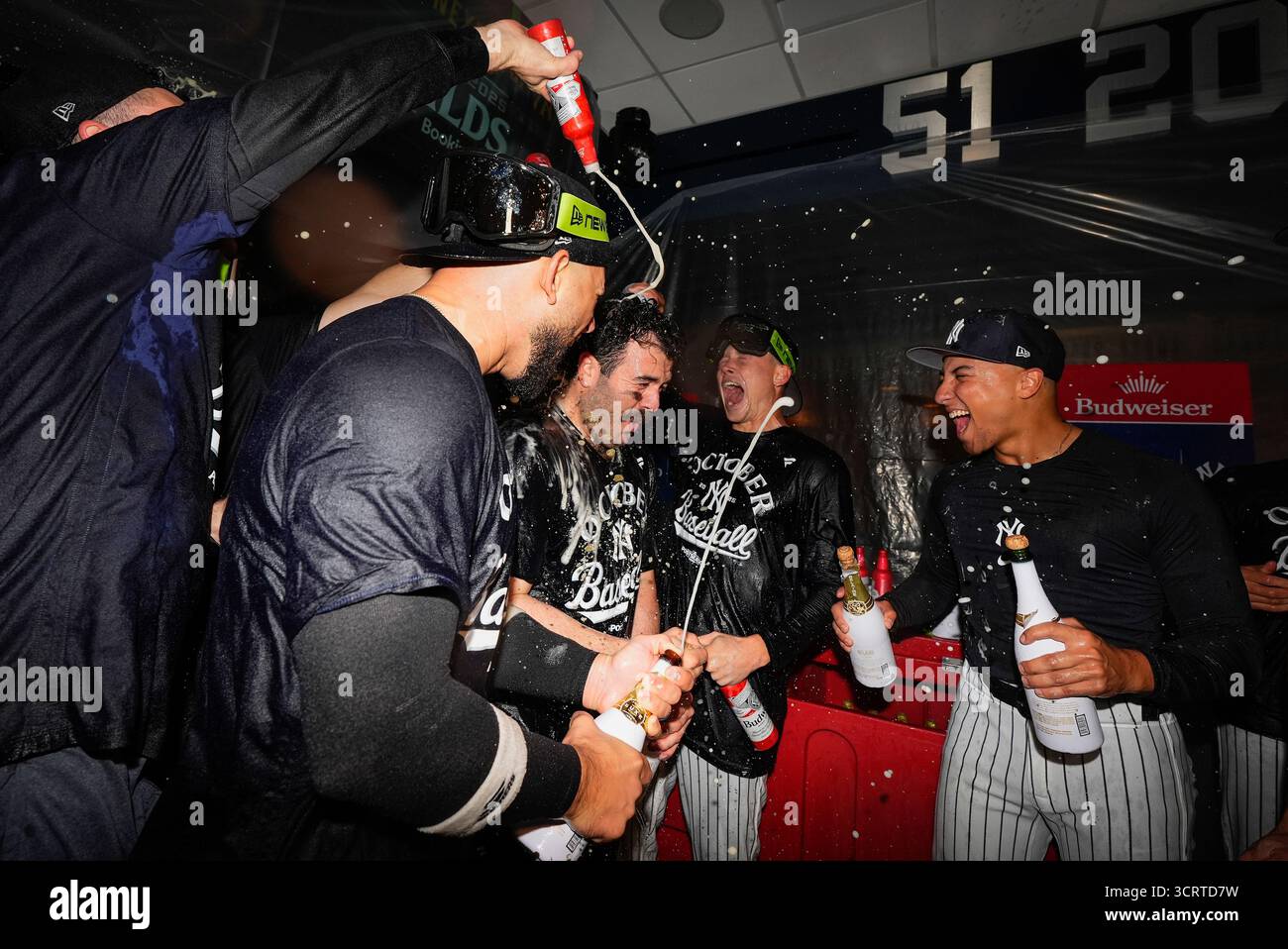 The New York Yankees celebrate in the locker room after defeating the ...