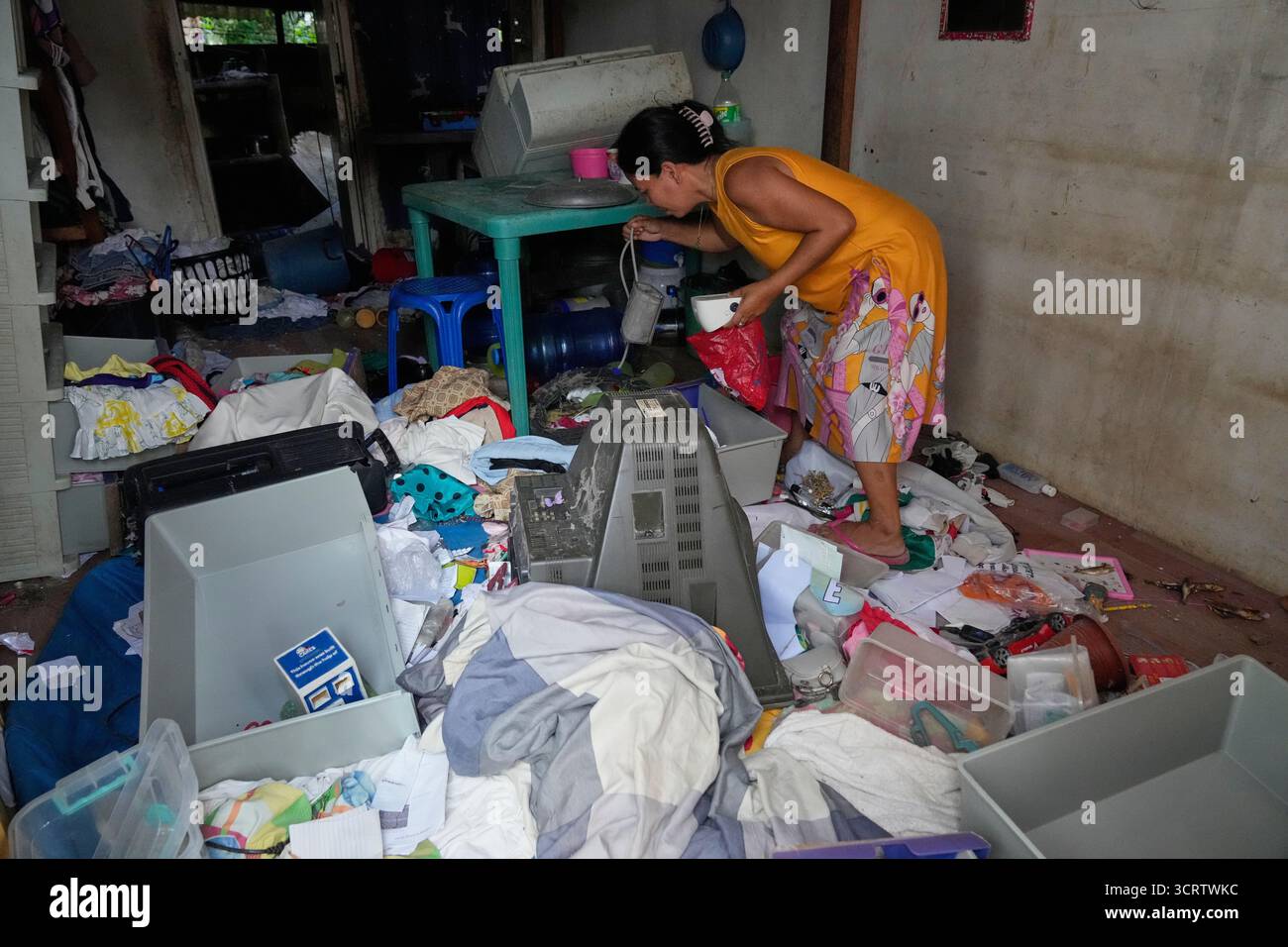 A resident salvages personal belongings from their earthquake damaged ...