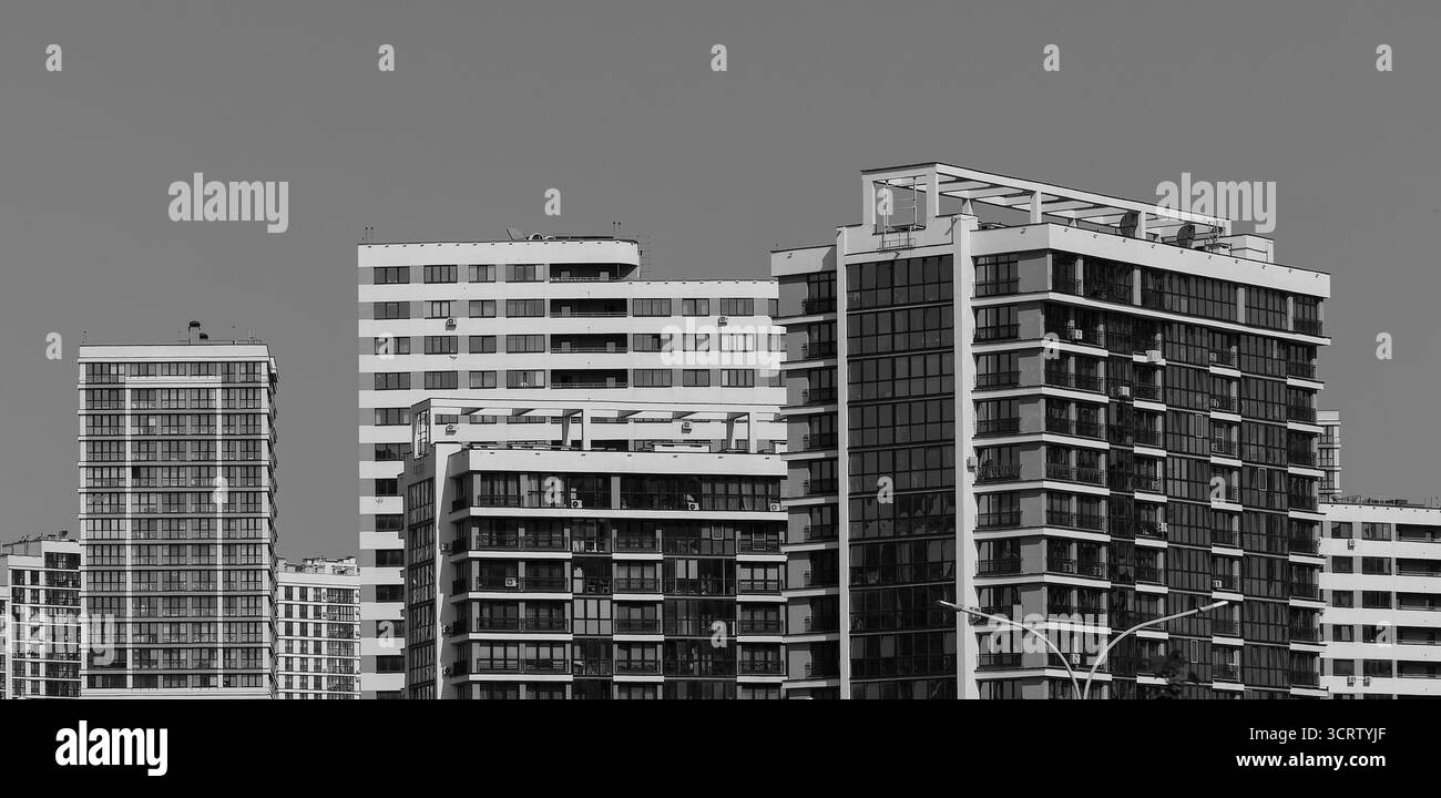 Tall modern building in grayscale with balconies and contemporary ...
