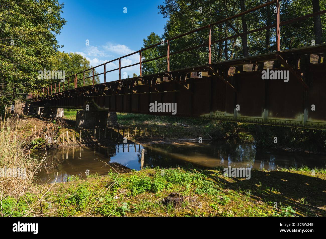landscape with an old steel railway bridge crossing the river Stock ...