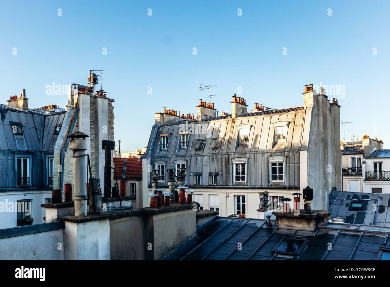 Classic Paris rooftops with chimneys and mansard windows Stock Photo ...