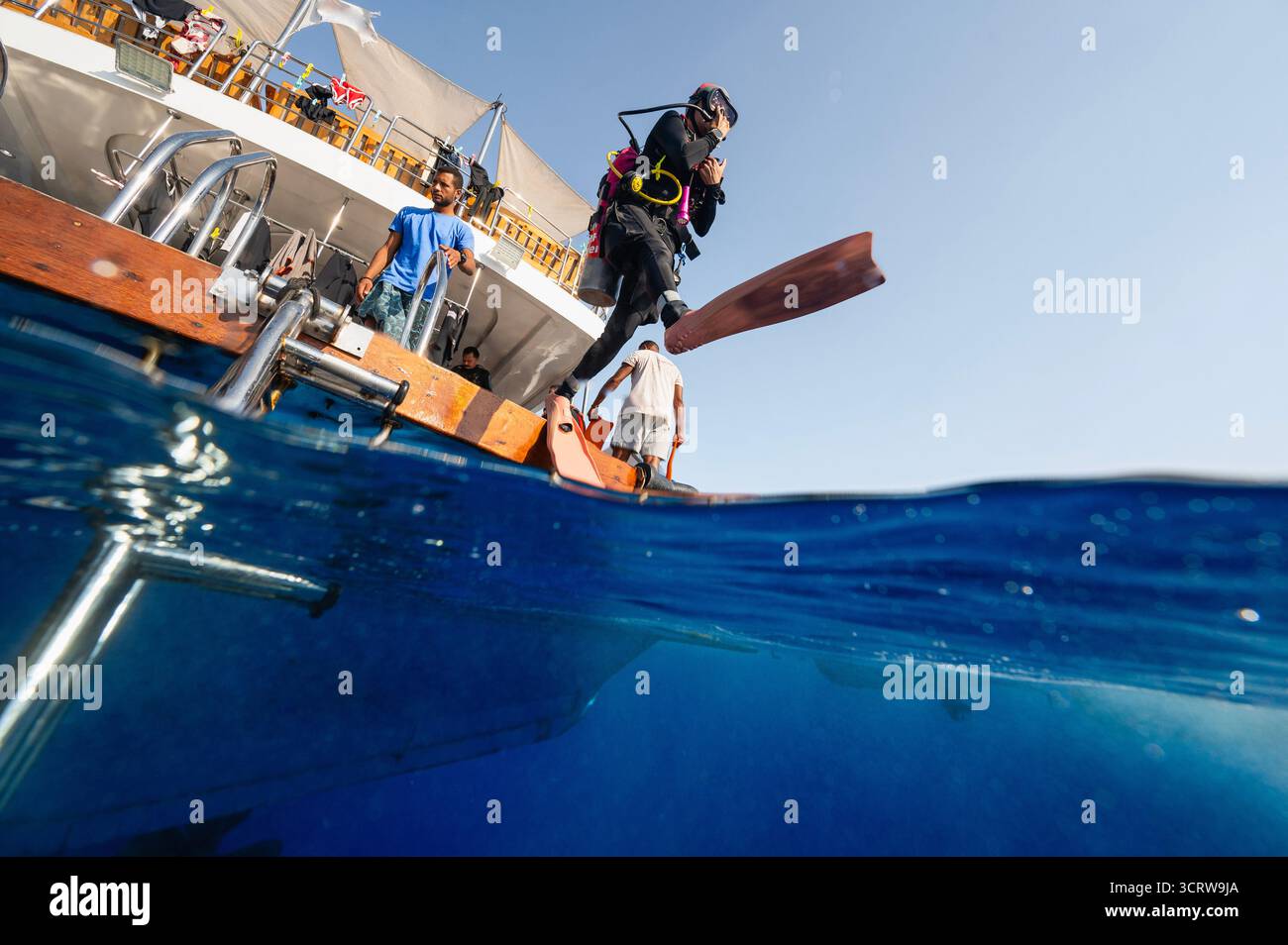 Diver jumping into the Red Sea from the dive deck of a boat Stock Photo ...