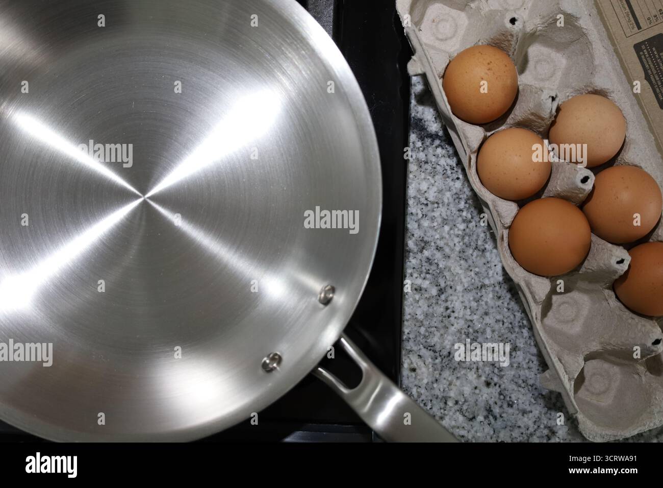Stainless Steel Skillet with Brown Eggs on Granite Counter Stock Photo ...