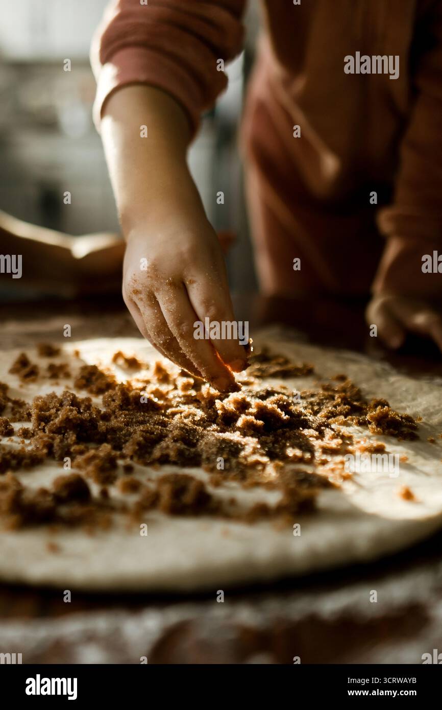 Child sprinkling brown sugar hi-res stock photography and images - Alamy