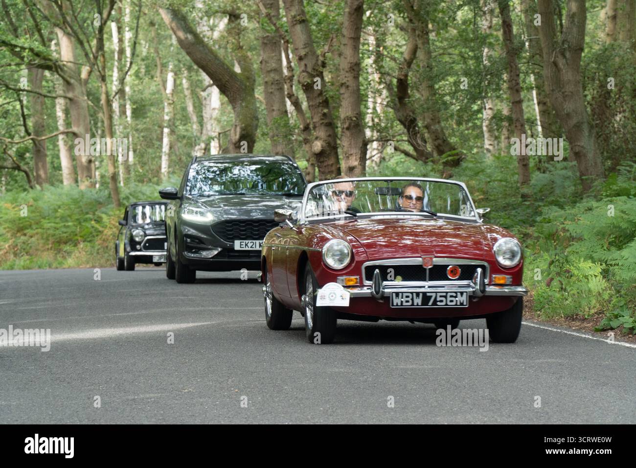 MG B British sports convertible Classic Car driving in country lane ...
