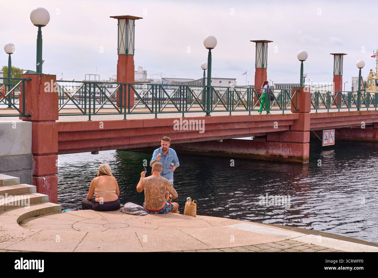 Helsingborg, Sweden ; August 12, 2025: Pedestrian bridge with red stone ...