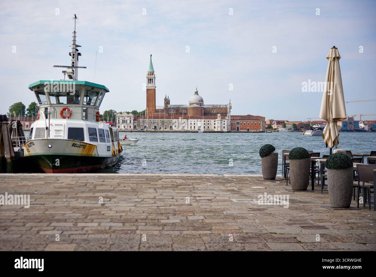 Boat on Venetian waterfront with historic architecture Stock Photo - Alamy