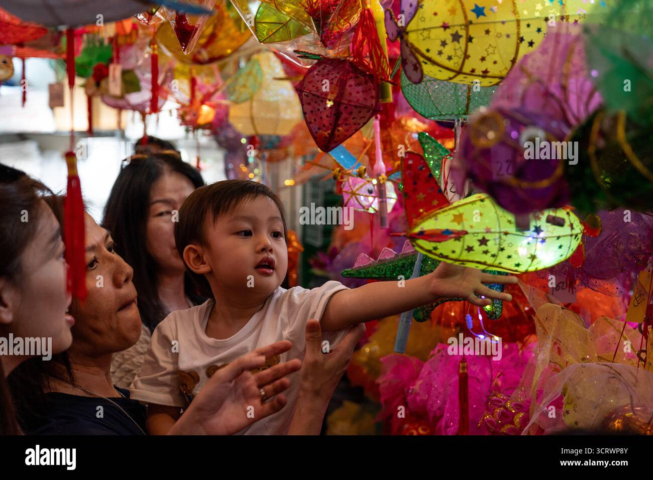 A boy looking at mid autumn festival lantern on display at a store on October 3, 2025 in Hong ...