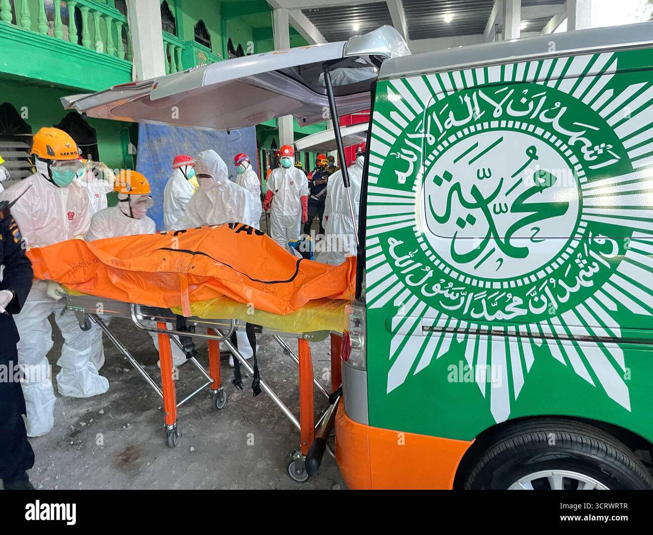 Rescuers put the body of a victim from a collapsed building at an ...