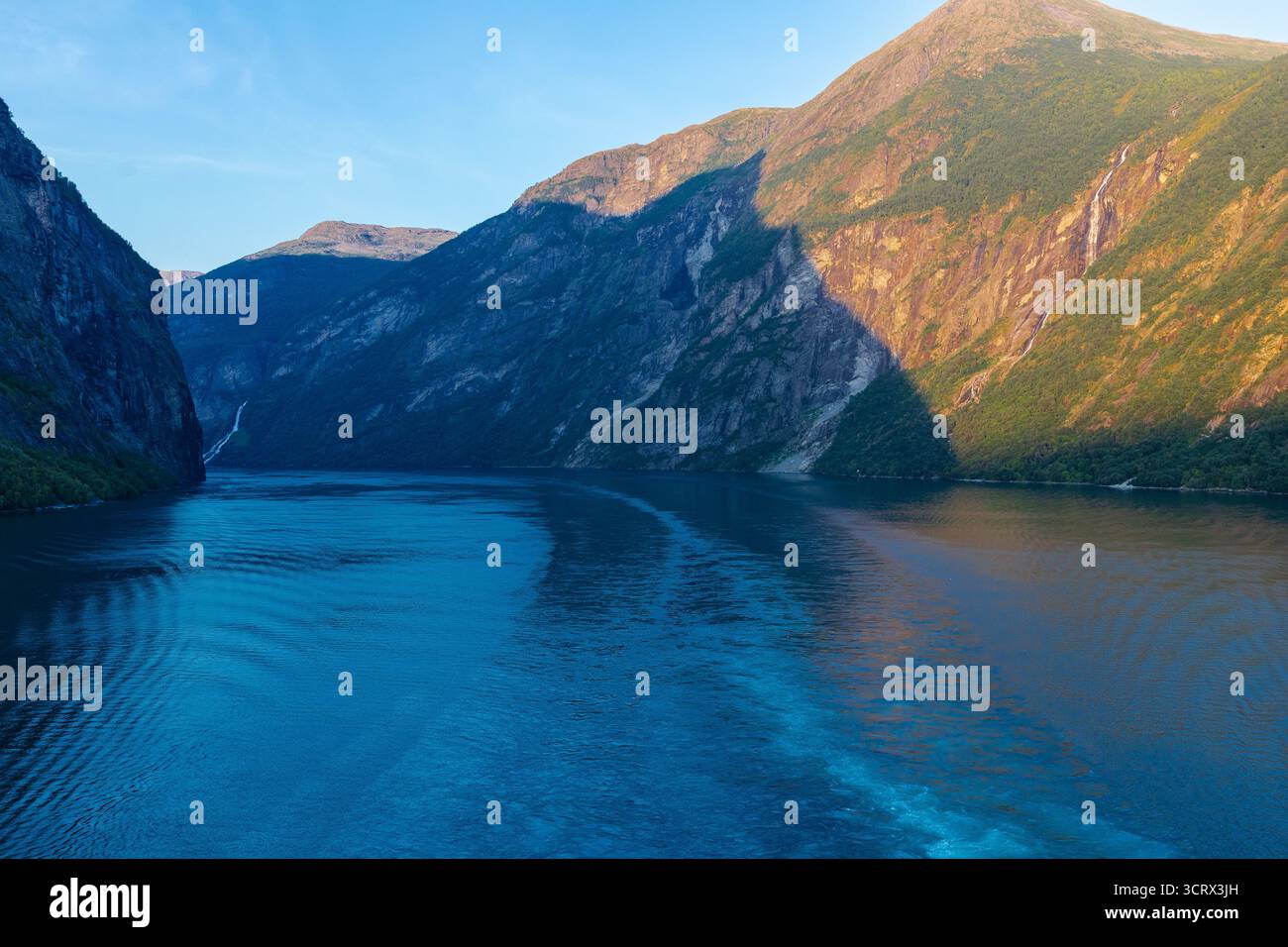 Sunset in the iconic UNESCO-protected Geiranger fjord in Norway with ...