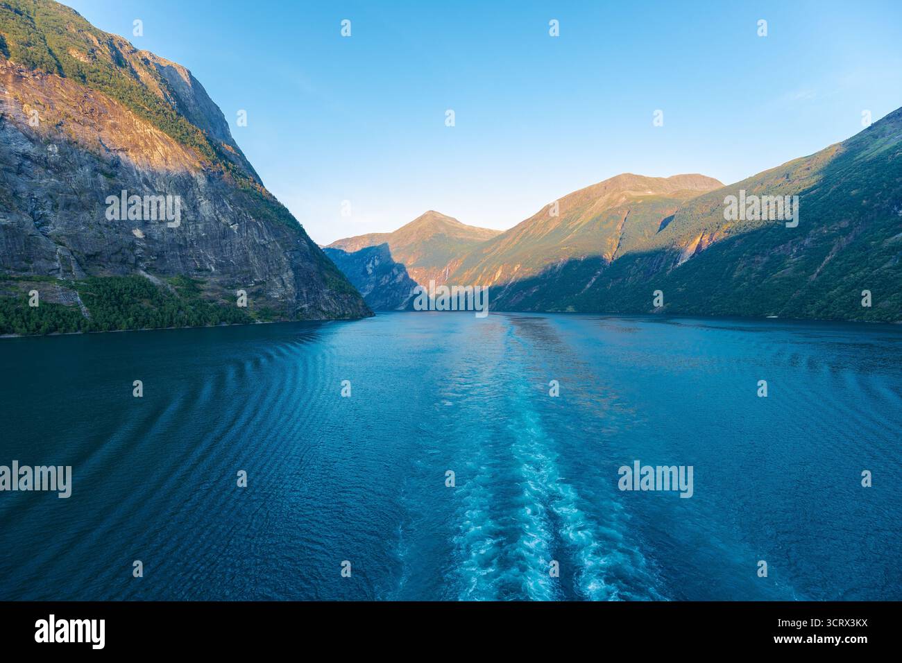 Sunset in the iconic UNESCO-protected Geiranger fjord in Norway with ...