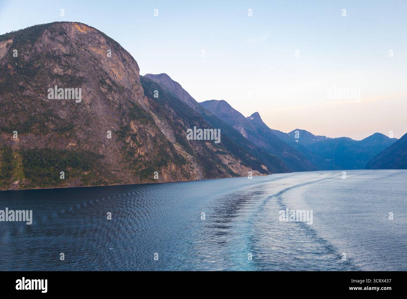 Sunset in the iconic UNESCO-protected Geiranger fjord in Norway with ...
