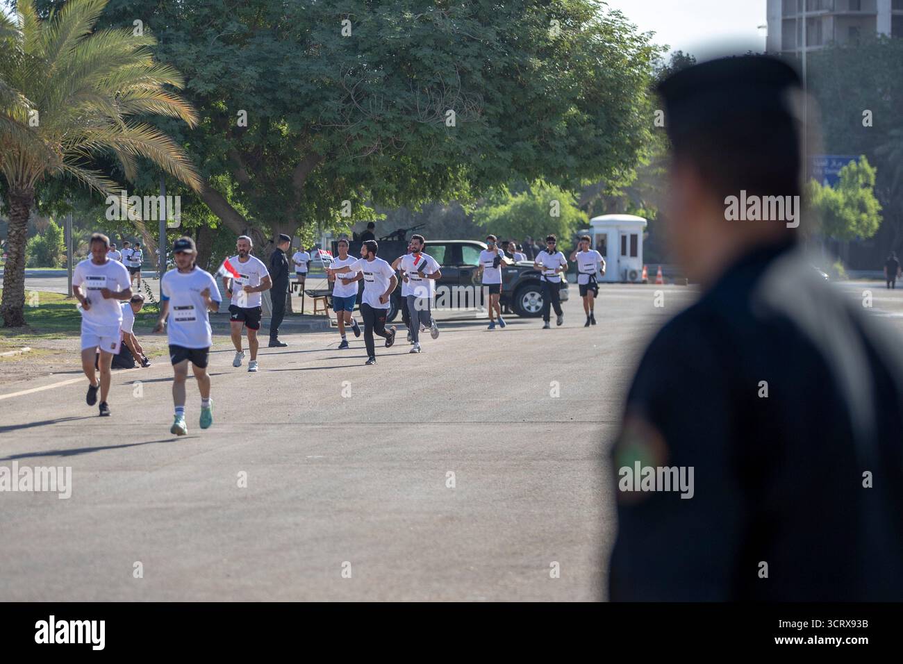 Athletes run during a marathon to celebrate Iraqi Independence Day in ...