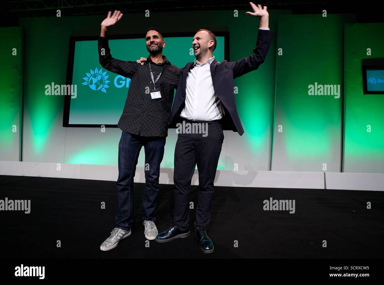 Green Party leader Zack Polanski (right) with his partner Richie Bryan on the stage following ...