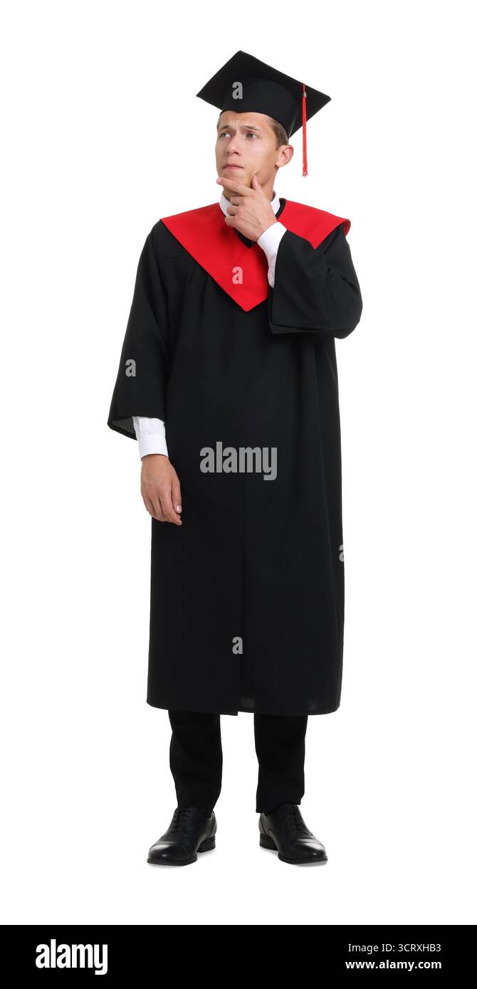 Thoughtful young man in graduation gown and mortarboard on white ...