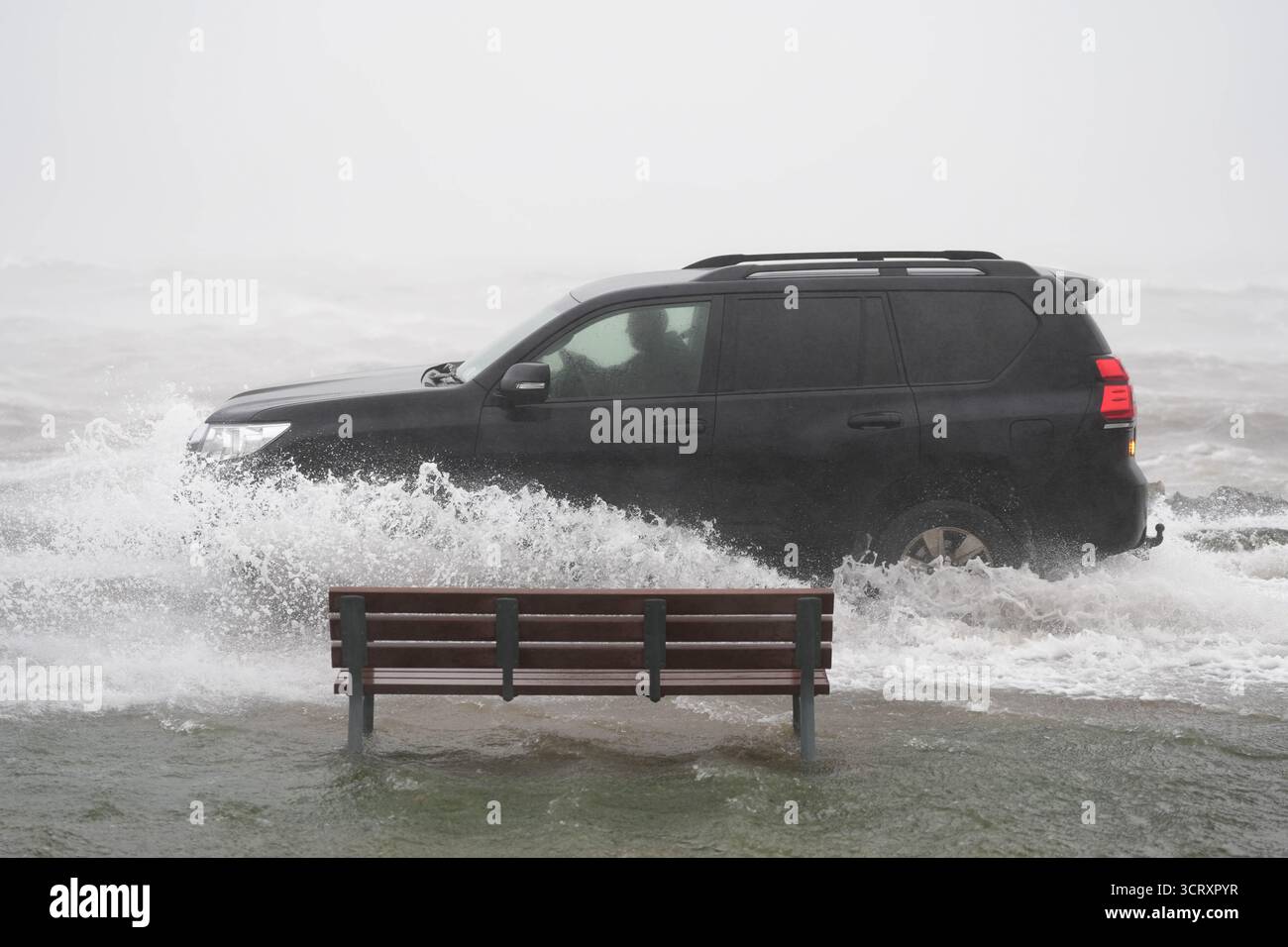 A car drives through floodwater in Galway. Storm Amy will bring ...