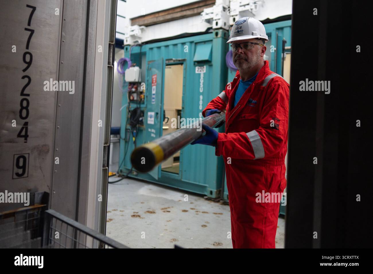 Expedition 501 project manager Jez Everest carries a core to a cold ...